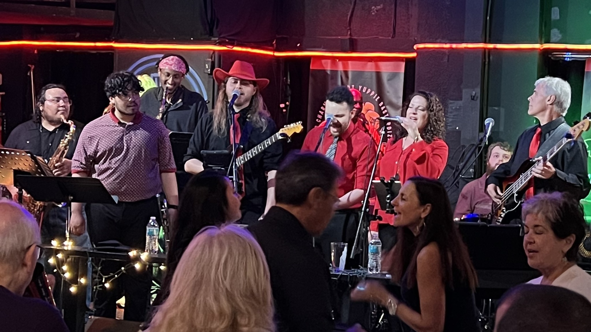 A group of people singing and playing instrumentsDescription ...